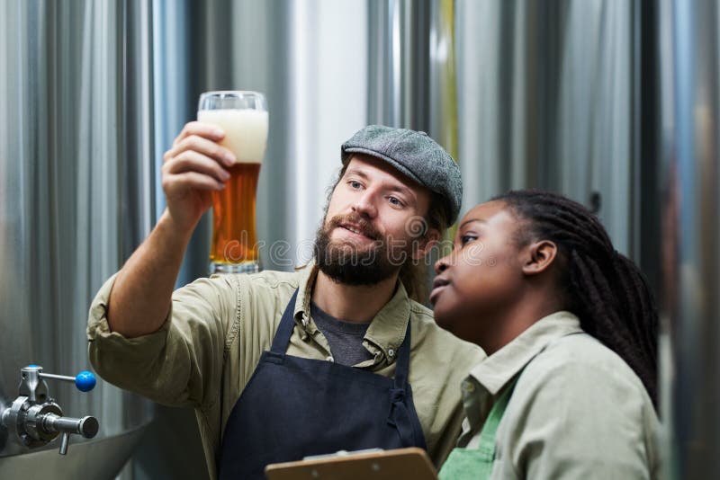 Brewery Workers Checking Beer Froth Stock Photo - Image of teamwork ...