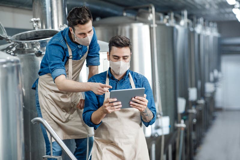 Brewery Workers Enter Data at Tablet and Operate Equipment Stock Image ...