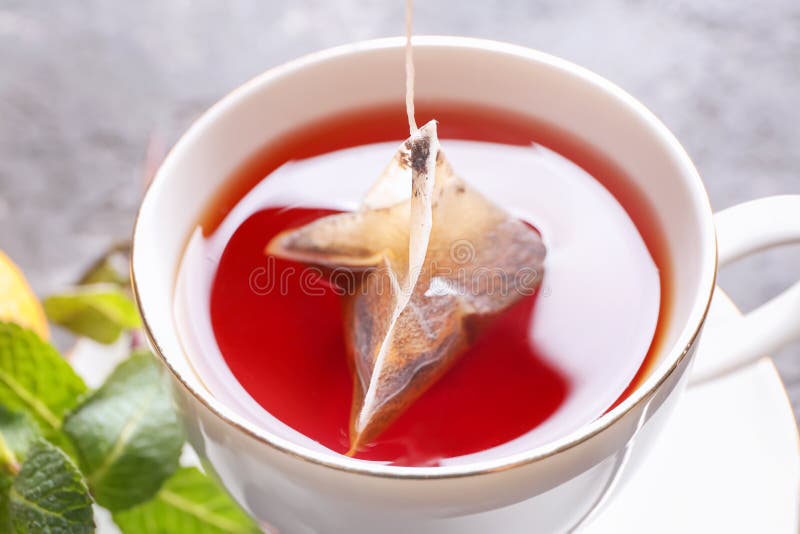 Brewing of Hot Tea in Cup, Closeup Stock Photo - Image of mint ...
