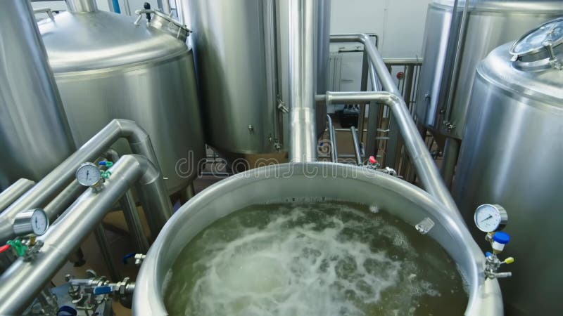 Brewing Process: Stainless Steel Fermentation Tanks with Bubbling Liquid in a Stock Video ...