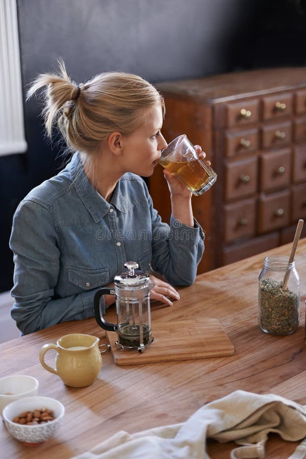 Brewing Some Herbal Tea. a Young Woman Drinking Herbal Tea. Stock Photo ...