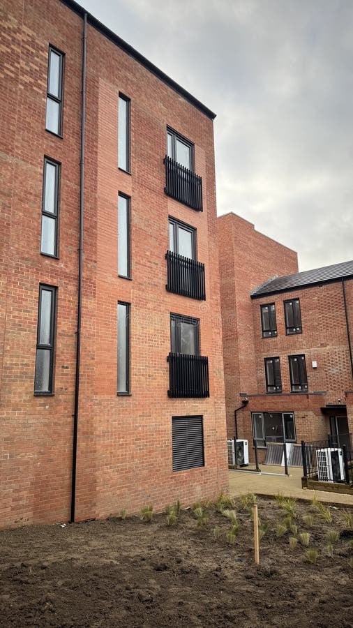 Brick Apartment Building Exterior with Balconies and Landscaping Stock ...