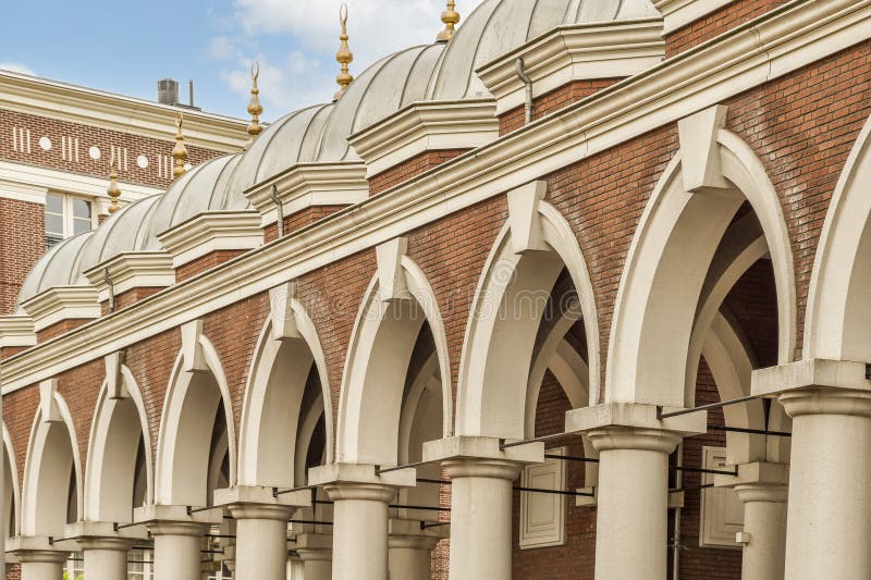 A Large Brick Building with White Columns and Arches Stock Photo ...