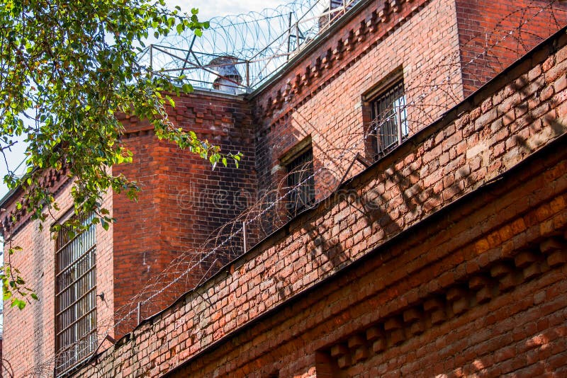 Brick Building with Barbed Wire Stock Photo - Image of barrier ...