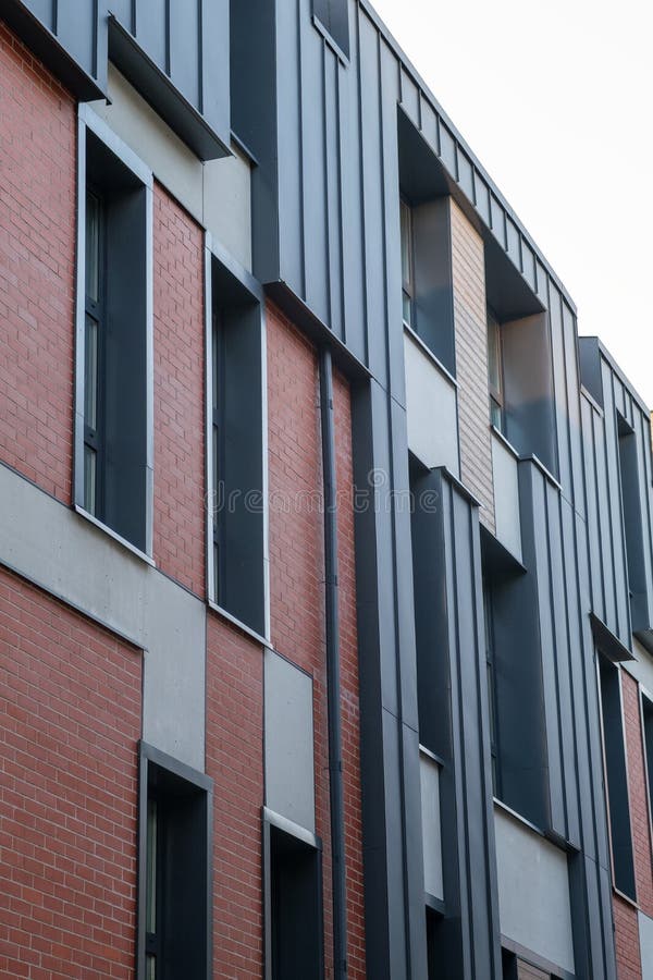 A Brick Building with a Black Roof. the Building Has a Lot of Windows ...