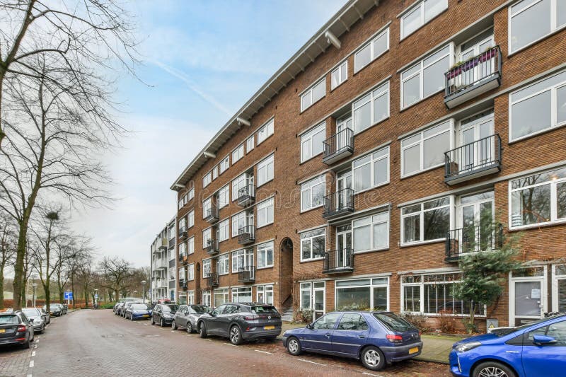 A Brick Building with Cars Parked in Front of it Editorial Photo ...