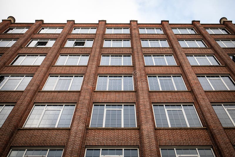 Brick Building Facade with Large White Framed Windows Stock Photo ...