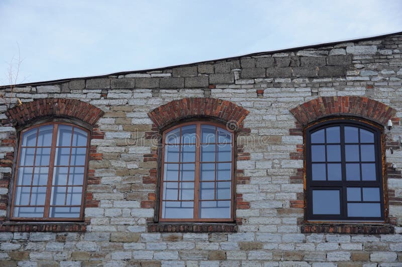 Brick Building Featuring Arched Glass Windows Towards Blue Sky Stock ...