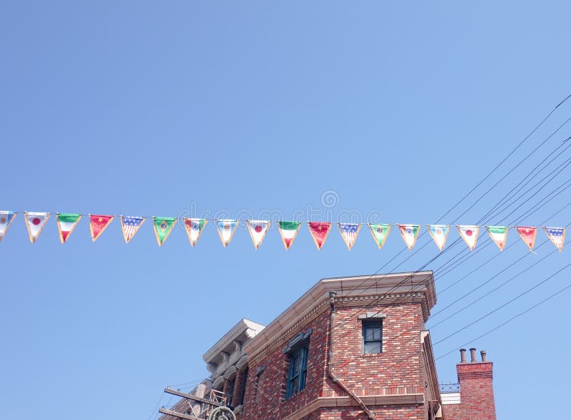 A Brick Building with Flags on it Stock Photo - Image of home ...