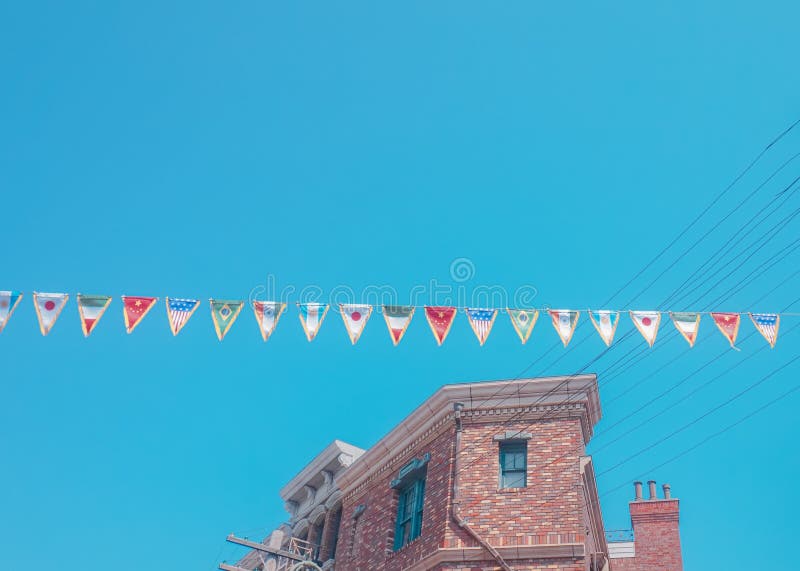 A Brick Building with Flags on it Stock Photo - Image of window, flags ...