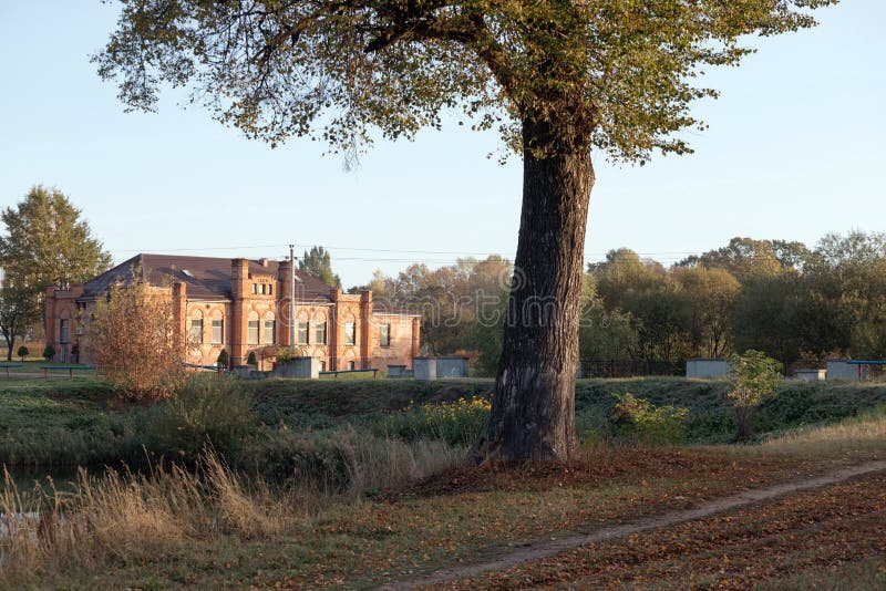 Brick Building Near the Water in Autumn Stock Photo - Image of garden ...