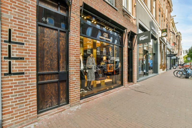 A Brick Building with a Window Display of a Store Editorial Photography ...