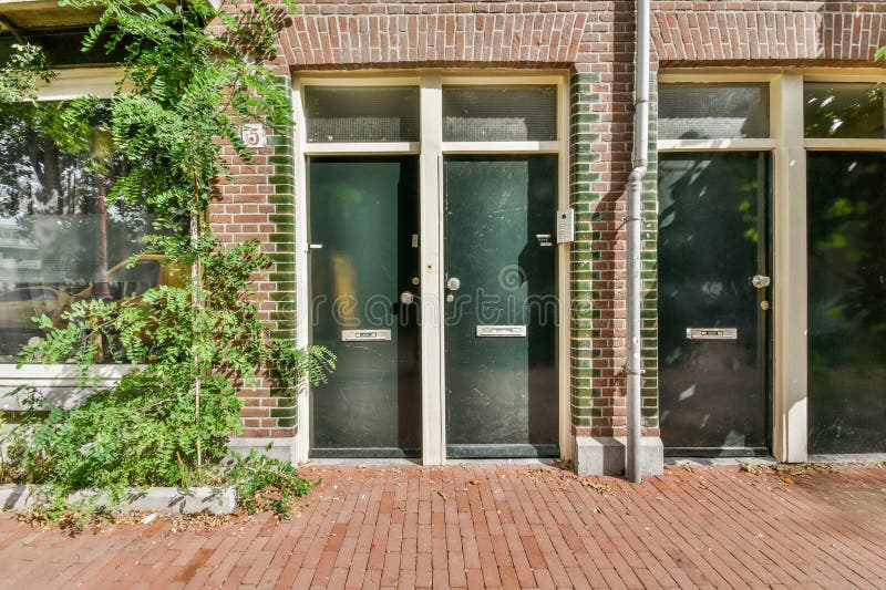 A Brick Building with Two Doors and a Brick Sidewalk Editorial Image ...
