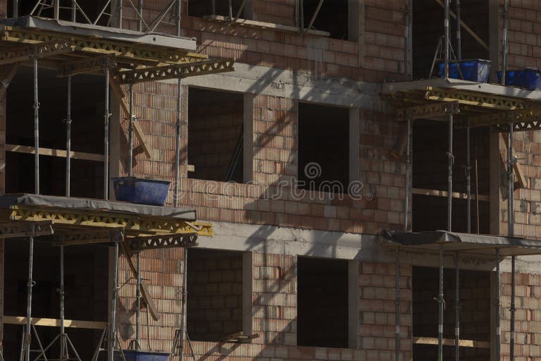 A Brick Building is Under Construction with Scaffolding Around it Stock ...