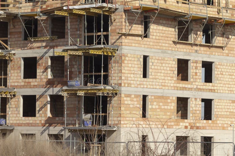 A Brick Building Under Construction, Surrounded by Scaffolding Stock ...