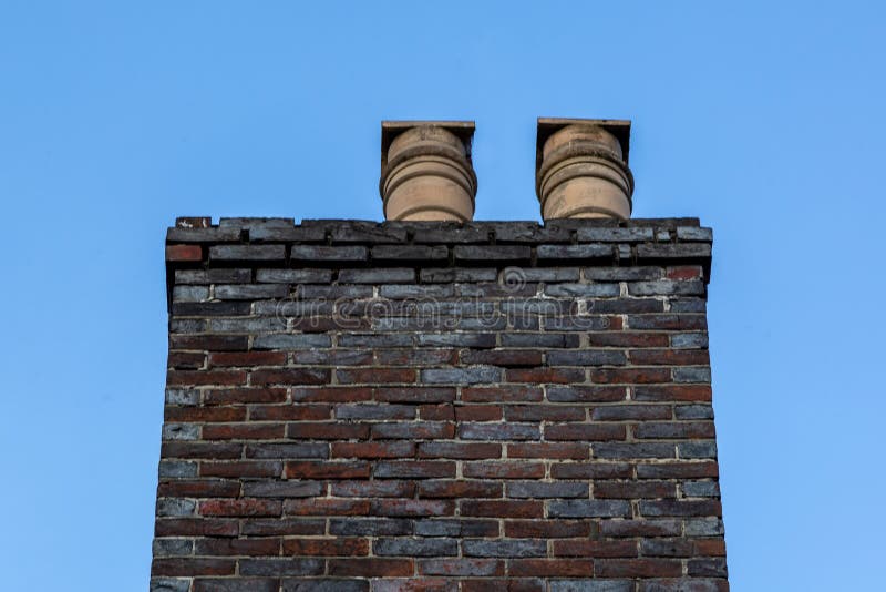 A Brick Chimney Stack with Clay Chimney Pots on Top Stock Photo - Image ...