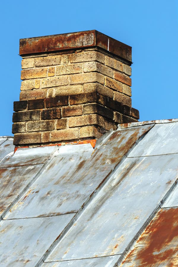 Brick House Chimney with a Metal Liner Above the Roof Stock Photo ...