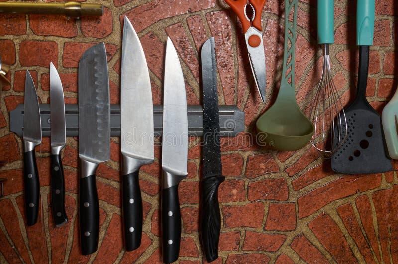 Brick-decorated Kitchen Wall with Kitchen Utensils Hanging on it Stock ...