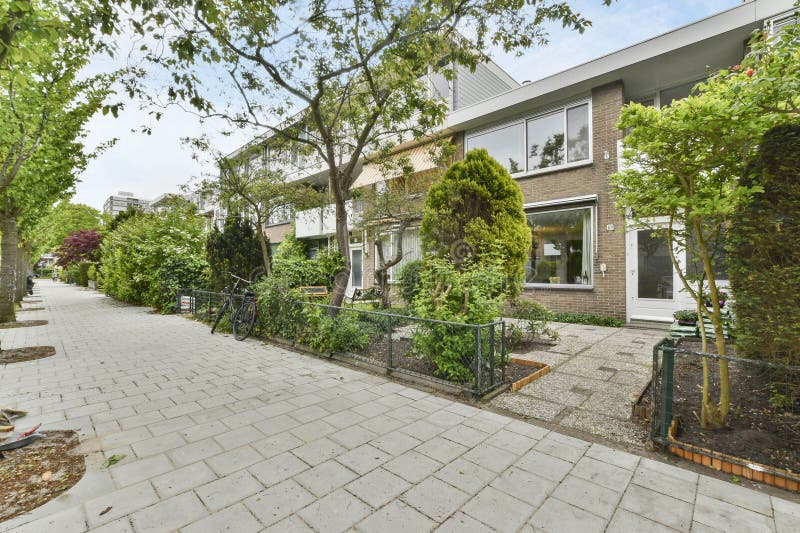 A Brick Sidewalk in Front of a House with Trees Editorial Image - Image ...