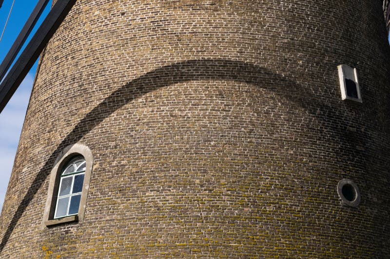 A Brick Tower with a Window and a Shadow on the Wall Stock Photo ...