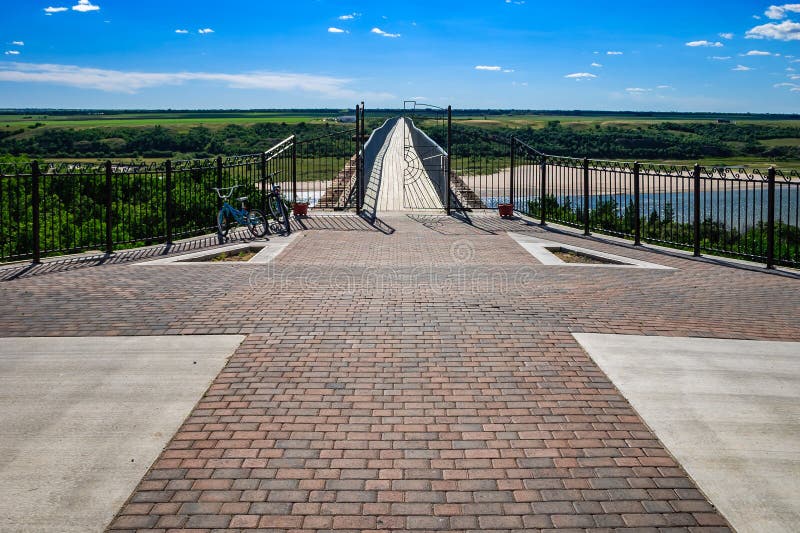 A Brick Walkway with a Bridge Over a River Stock Image - Image of ...