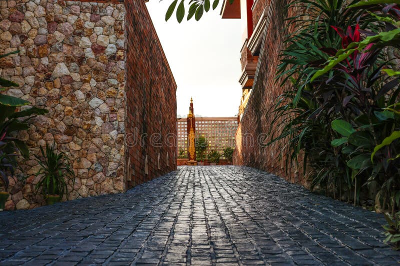 A Brick Walkway on the Street. the Path is Lined with Plants and Trees ...
