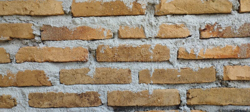 A Brick Wall Arranged in Horizontal Rows and Held Together with White ...