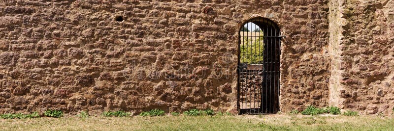 Brick Wall with a Barred Door Stock Photo - Image of arch, facade ...