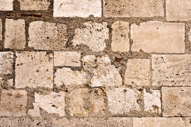Brick Wall with a Cement Overlay, Featuring a Textured Pattern of Small ...