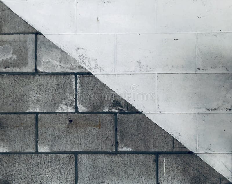 The Brick Wall is Half-painted with White Paint and Half without Paint ...