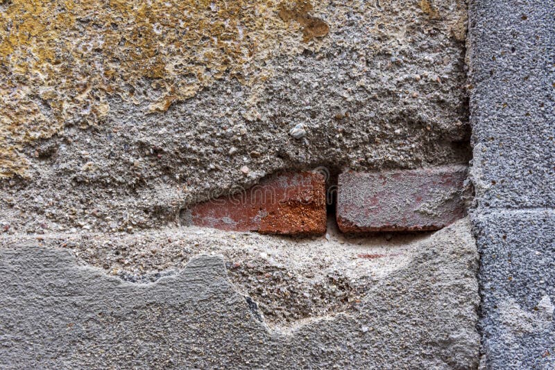 A Brick Wall Plastered with Sand and Cement that is Falling Apart Stock ...