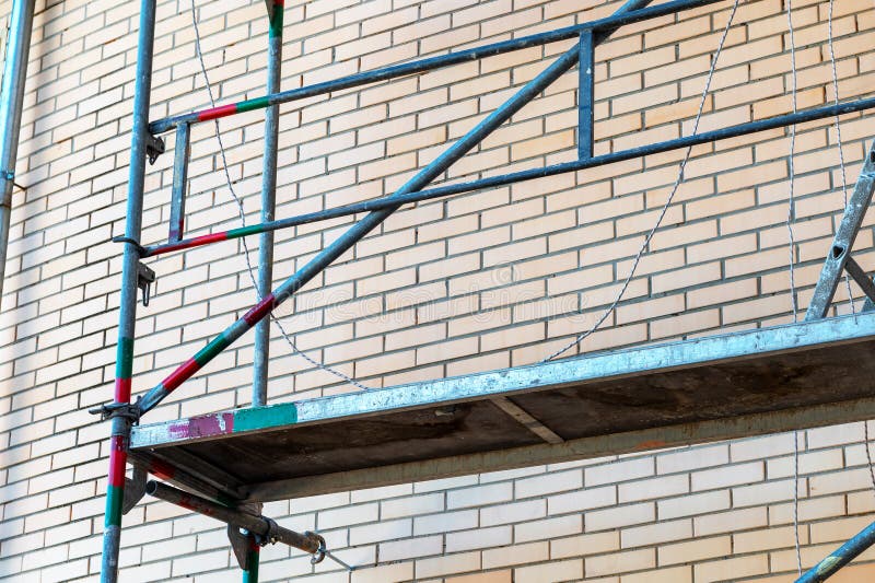Brick Wall and Scaffolding. Scaffolding Near the Building Stock Photo ...