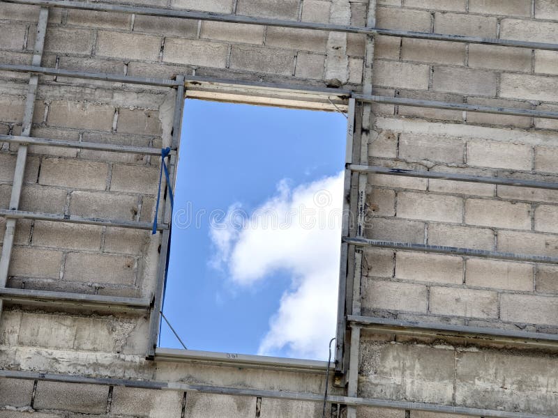 A Brick Wall with Small Window Under Construction Stock Photo - Image ...