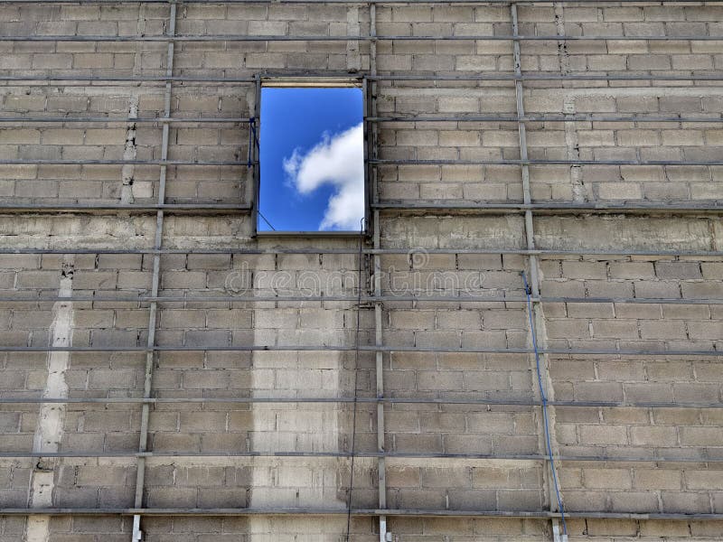 A Brick Wall with Small Window Under Construction Stock Image - Image ...