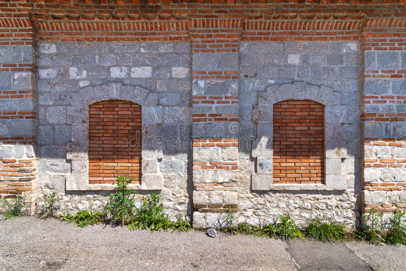 Brick Wall with Two Arched Windows. the Wall is Made of a Combination ...