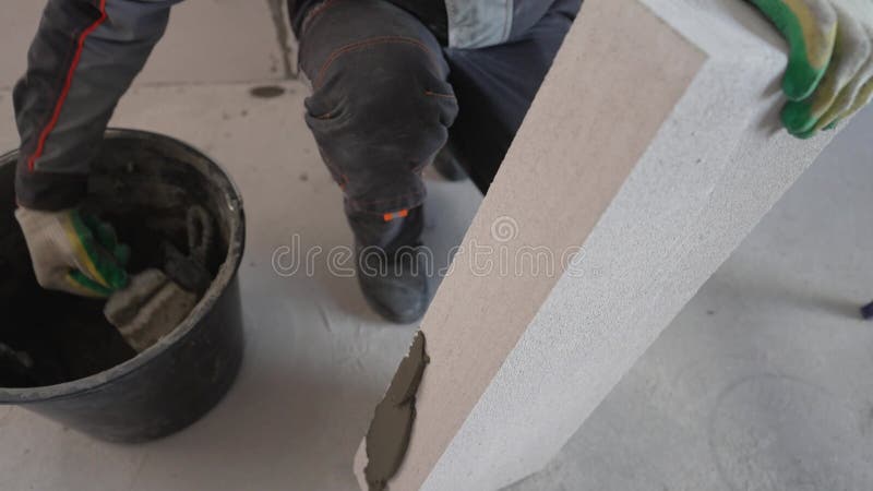 A Bricklayer Applies Glue To Aerated Concrete Blocks With A Spatula A Worker Applies Mortar To