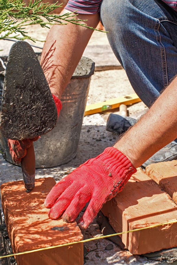 Bricklayer with brick stock image. Image of arranging - 50243157