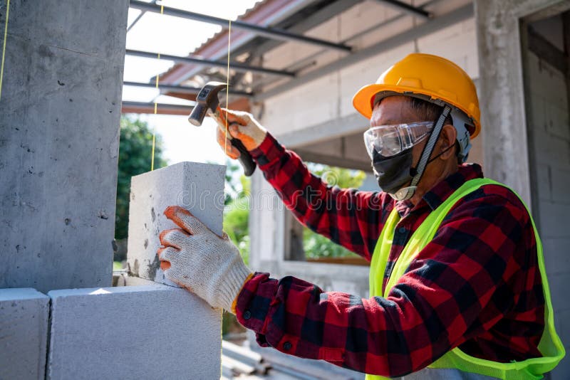 Bricklayer Builder Working with Autoclaved Aerated Concrete Blocks ...