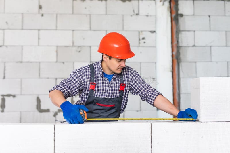 Bricklayer Builder Working with Autoclaved Aerated Concrete Blocks ...