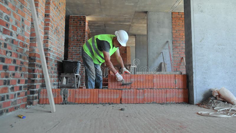Bricklayer Building Interior Wall at Construction Site. a Construction ...