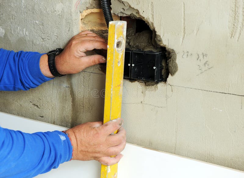 Bricklayer Checking the Leveling of a Porcelain Stoneware Floor with ...