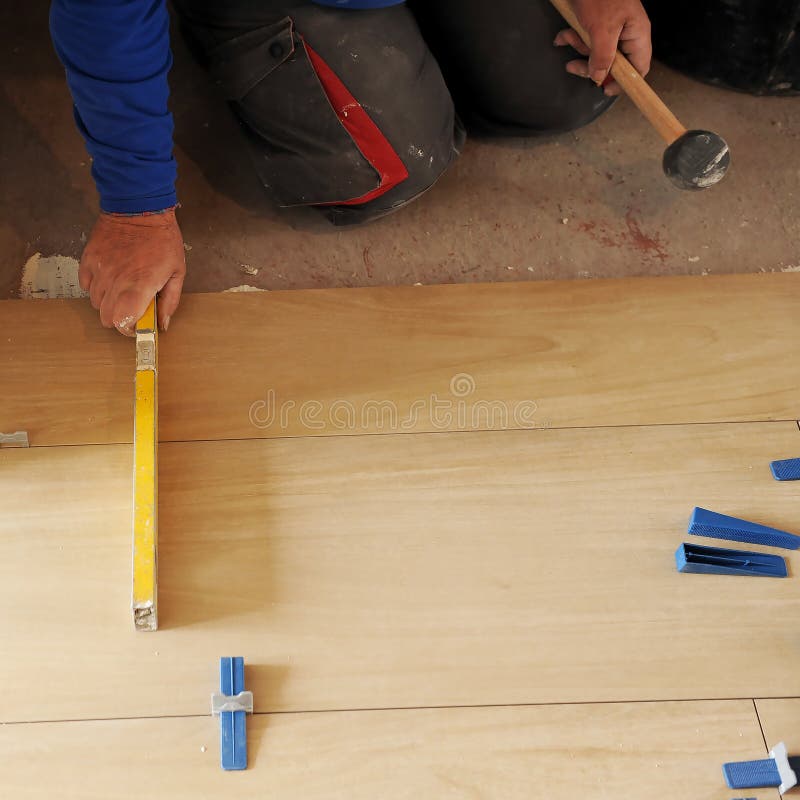 Bricklayer Checking the Leveling of a Porcelain Stoneware Floor with ...