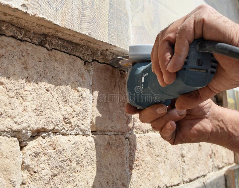 Bricklayer Cutting an Old Solid Brick Wall with Electric Radial Cutter ...