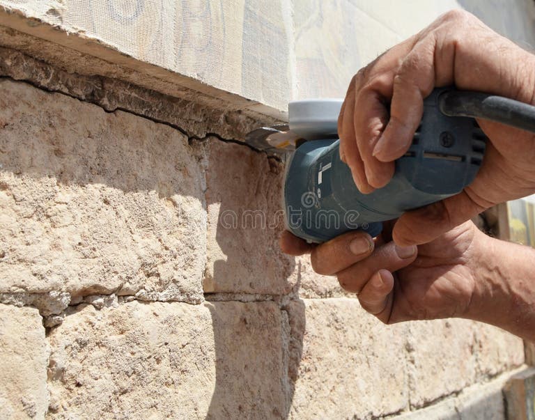 Bricklayer Cutting an Old Solid Brick Wall with Electric Radial Cutter ...