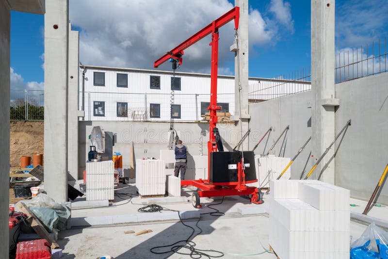 A Bricklayer Erects a Concrete Wall on a Construction Site Editorial ...