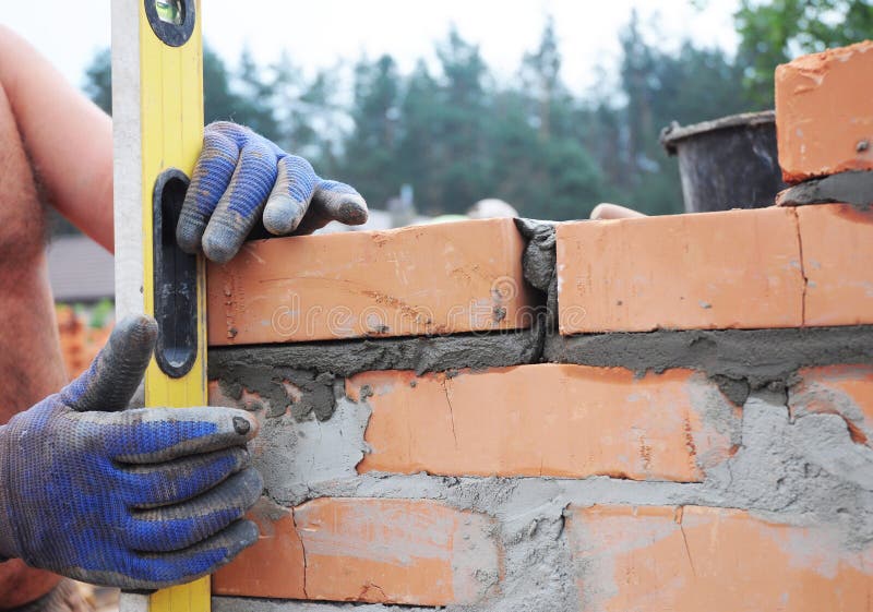 Bricklayer Laying Bricks and Measuring Brick Wall with Spirit Le Stock ...