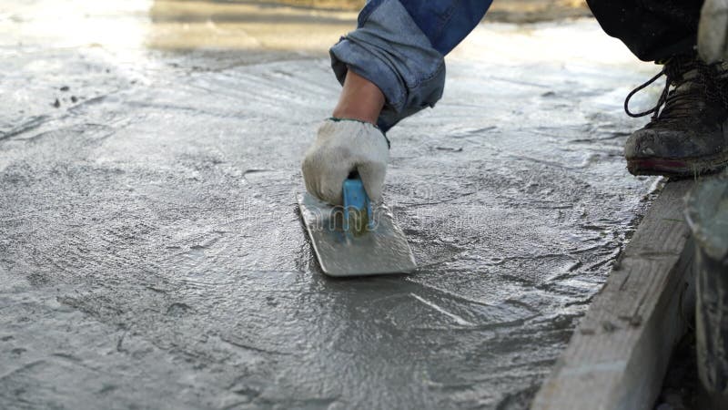 Bricklayer Laying Concrete To Create a Cement Floor Inside the House ...