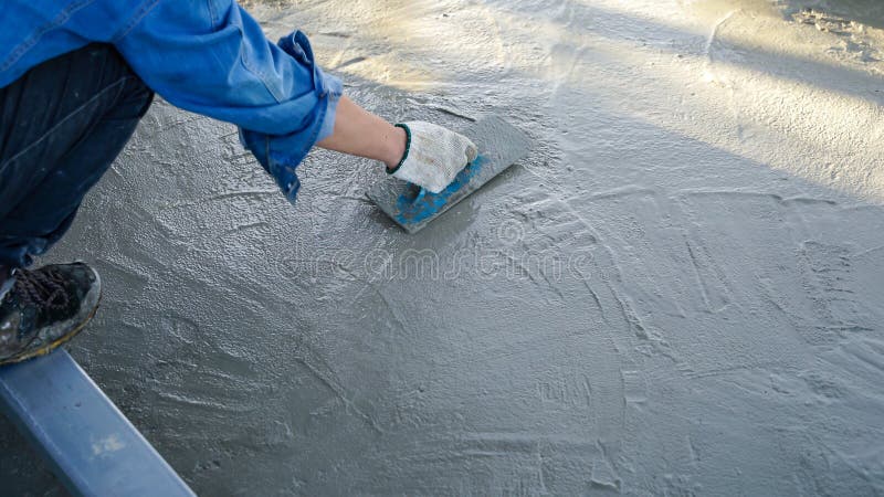 Bricklayer Laying Concrete To Create a Cement Floor Inside the House ...