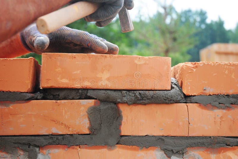 Bricklayer Lays Bricks on Cement Mortar. Builder Hold Brick with Hand ...