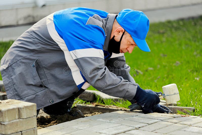 Bricklayer Lays Paving Slabs Outside. Working Man Performs Landscaping ...